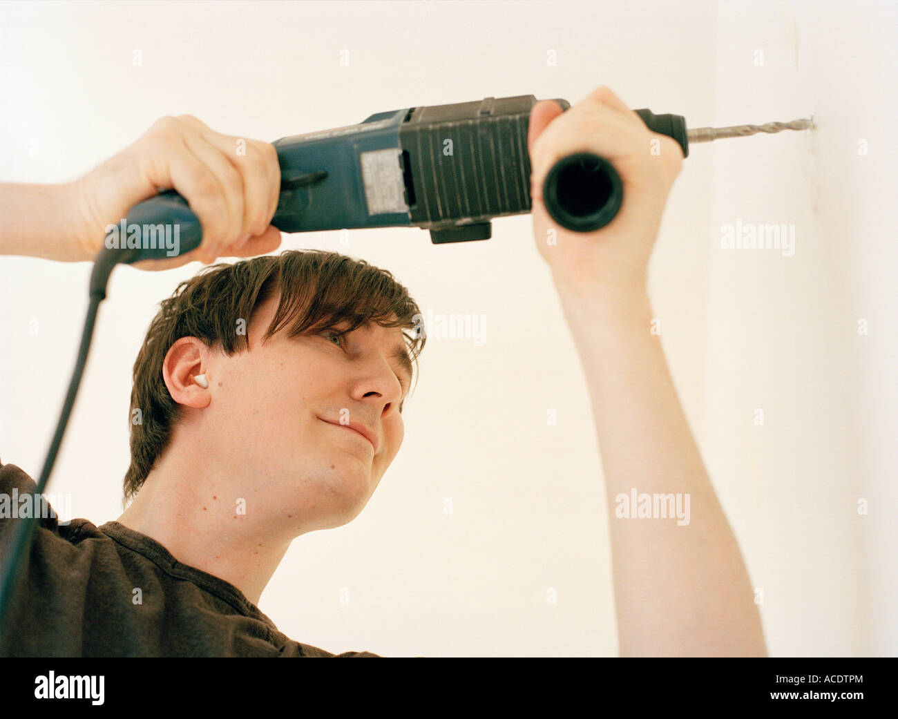 A man with a drill Stock Photo - Alamy