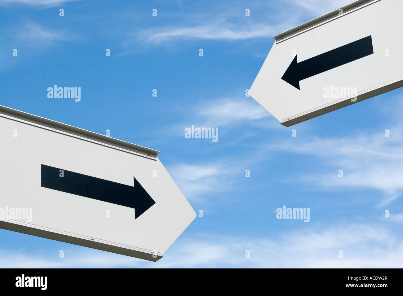 Close up of two arrow signs pointing in towards each other Stock Photo ...