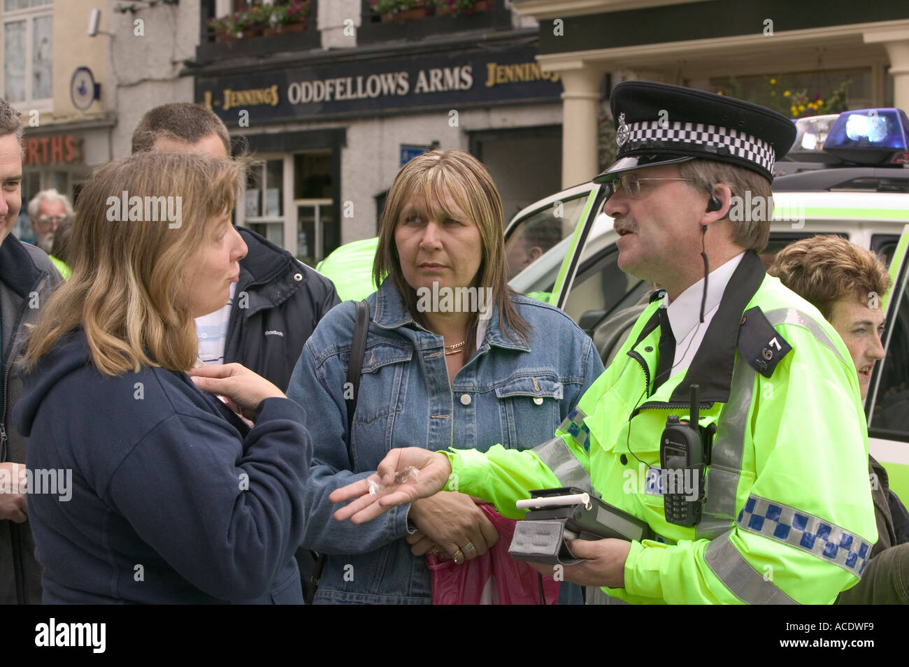 policeman breathalising a member of the public in a road safety ...