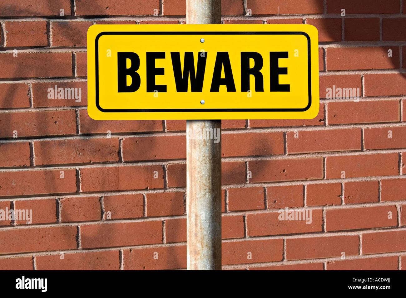 Yellow BEWARE sign Stock Photo - Alamy