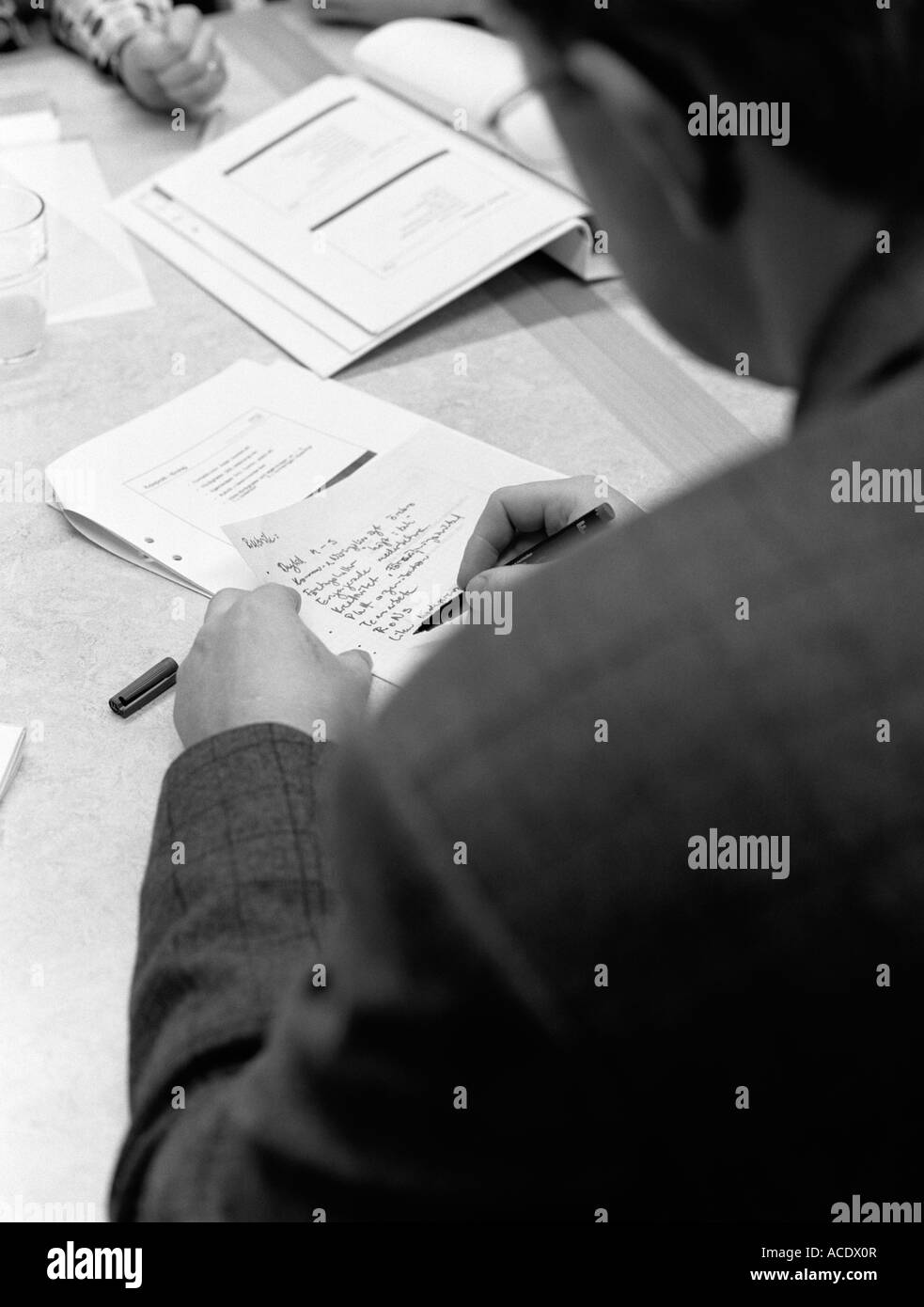 A man writing rear view Stock Photo - Alamy