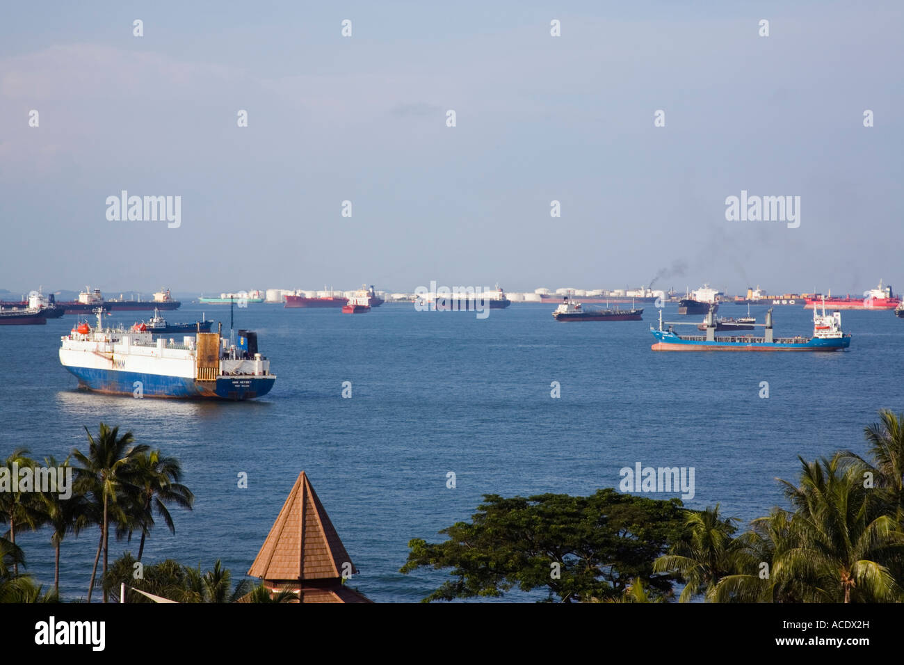 Cargo Ships laying at anchor offshore in harbour off Sentosa Island ...