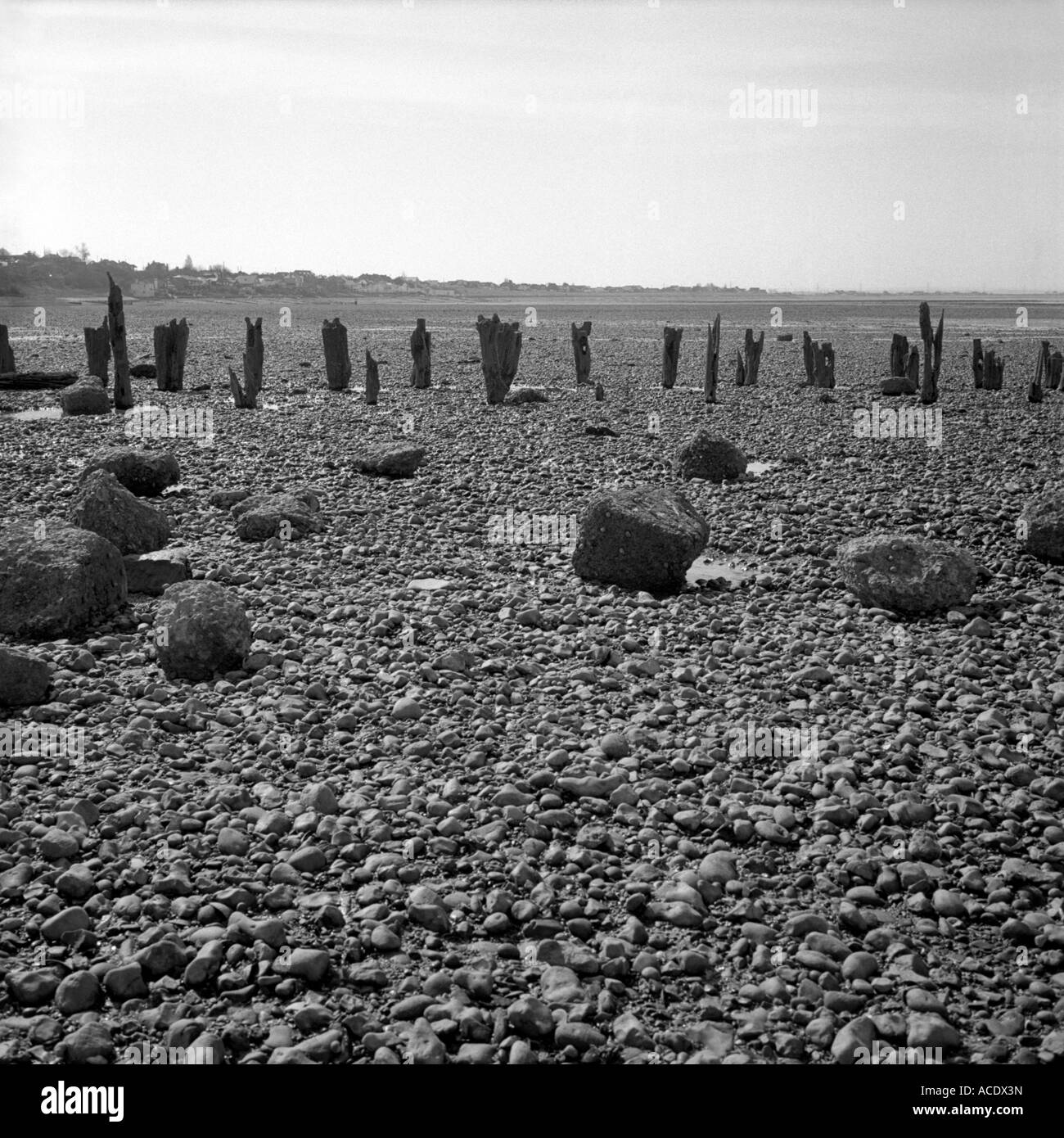 Landscape image of a pebble beach with large boulders Stock Photo - Alamy