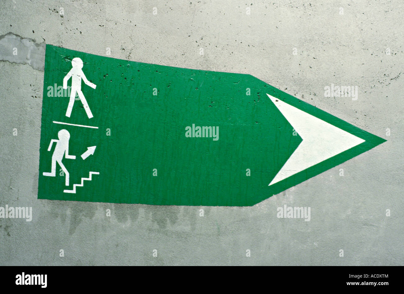 Arrow sign on wall indicating exit or way out for pedestrians Stock ...