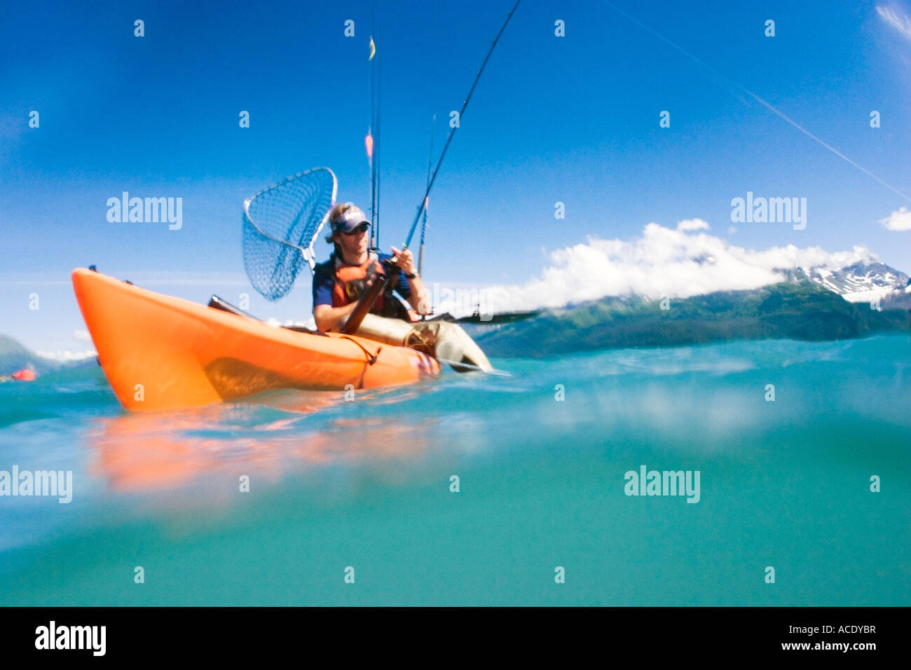 Male fishreman in kayak fishing for halibut in Resurrection Bay Seward ...