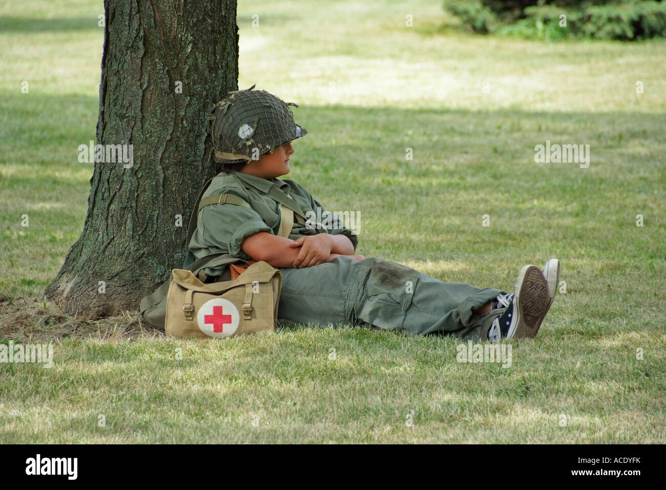 A young soldier is resting under the shade of a tree during the civil ...