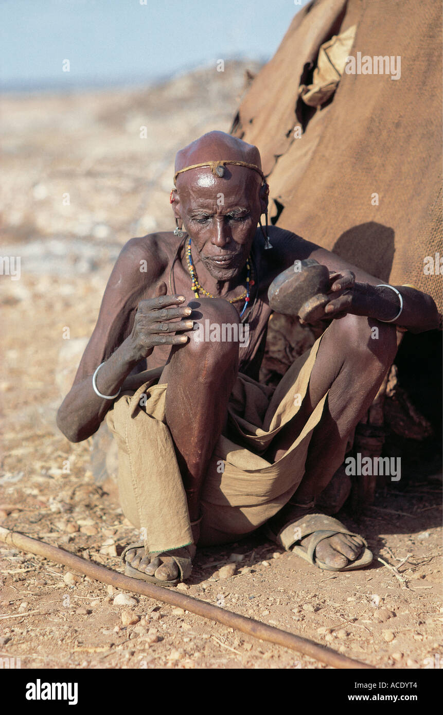 Old Rendille man anointing himself with ghee during ALMHATO ceremony ...