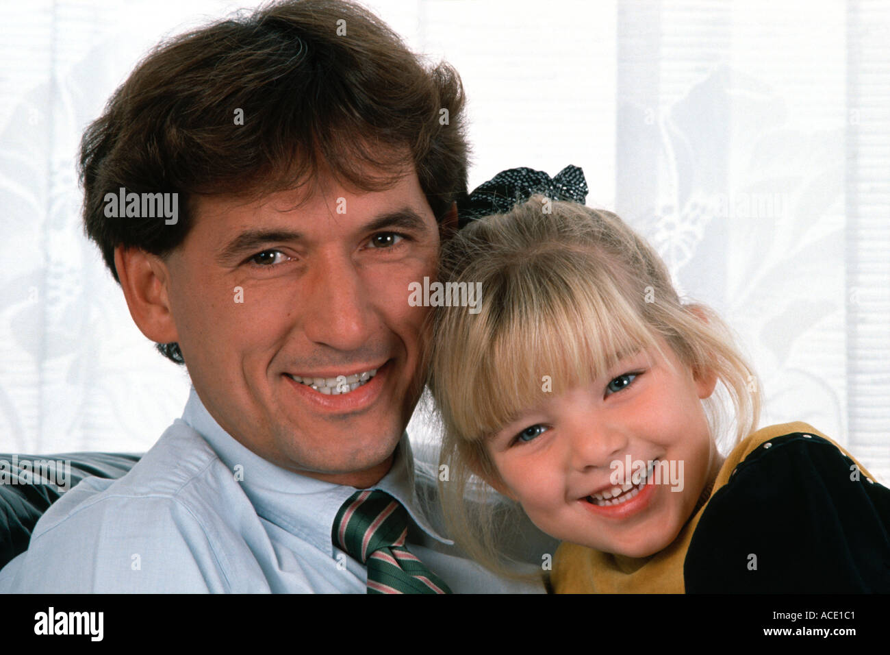 Portrait of European Caucasian father and his blond daughter smiling to ...