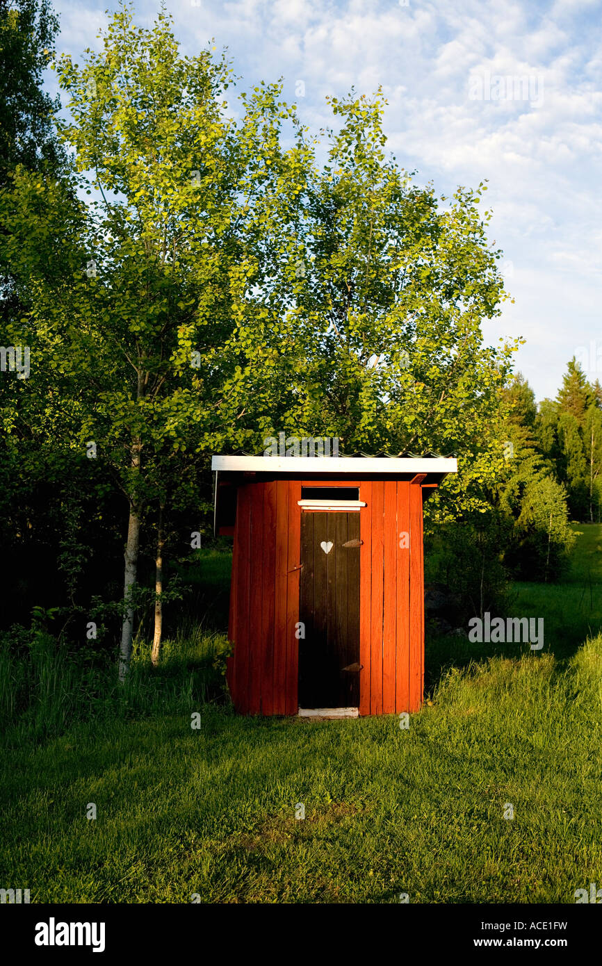 A red-painted outhouse Stock Photo - Alamy