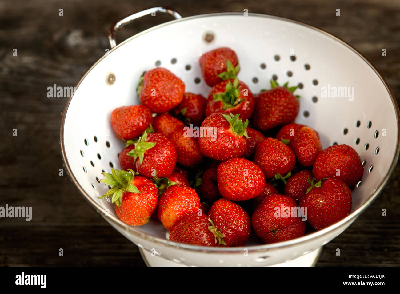 Strawberries in a colander Stock Photo - Alamy