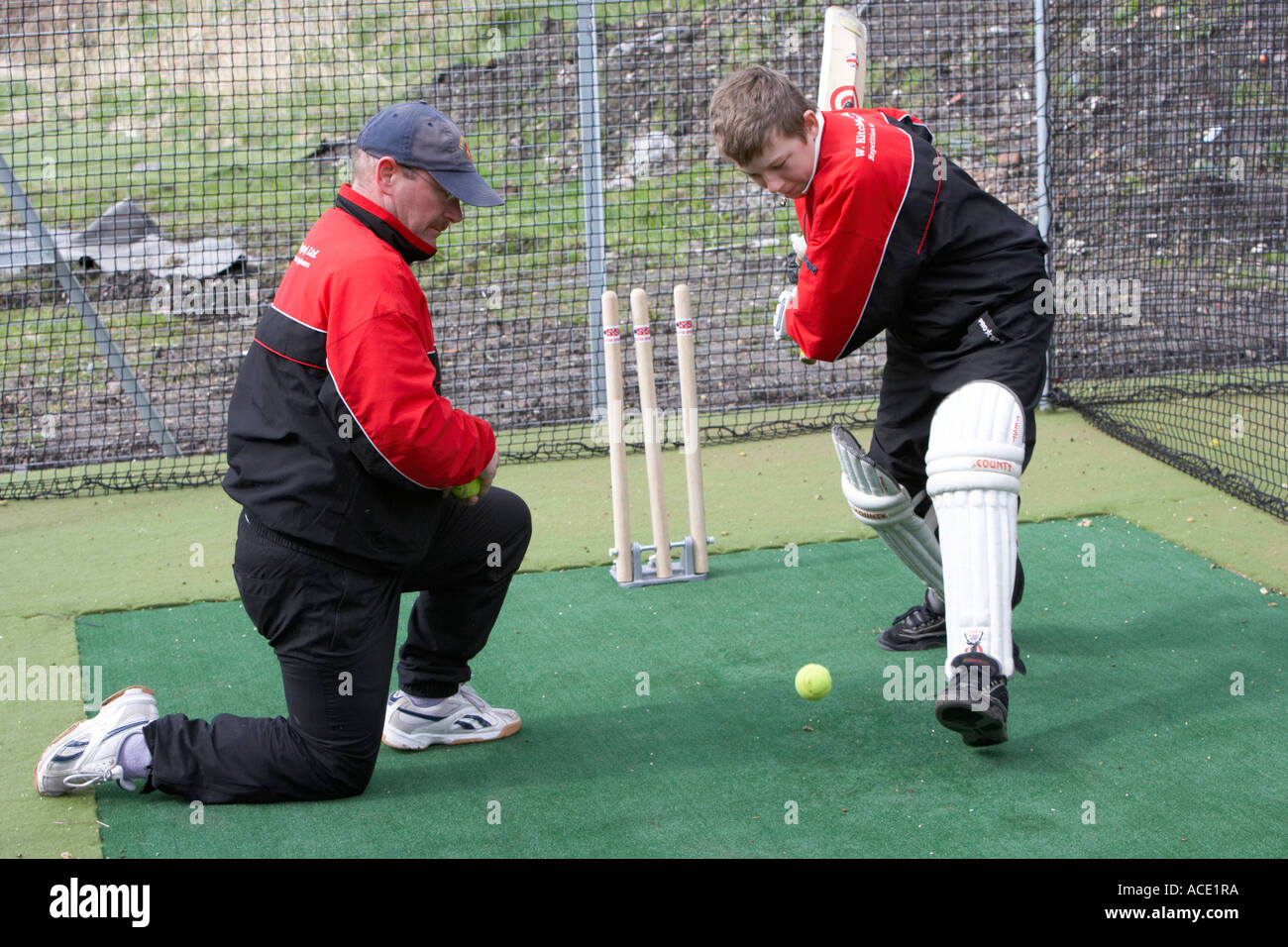 junior cricket player practicing with his trainer Stock Photo - Alamy