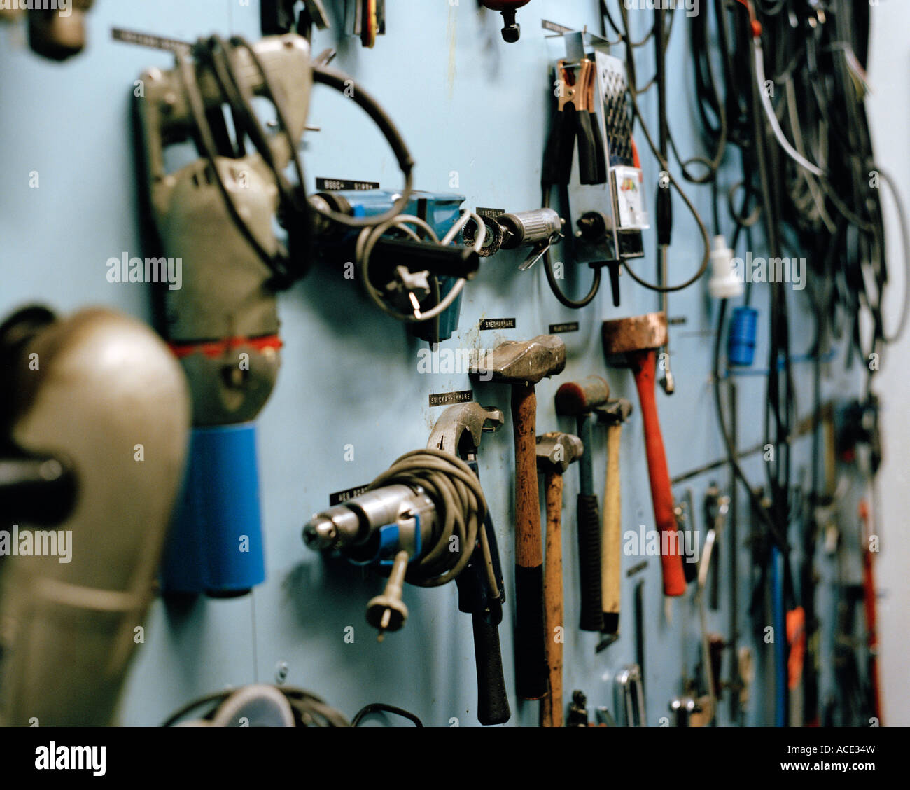 Tools haning on a wall close-up Stock Photo - Alamy