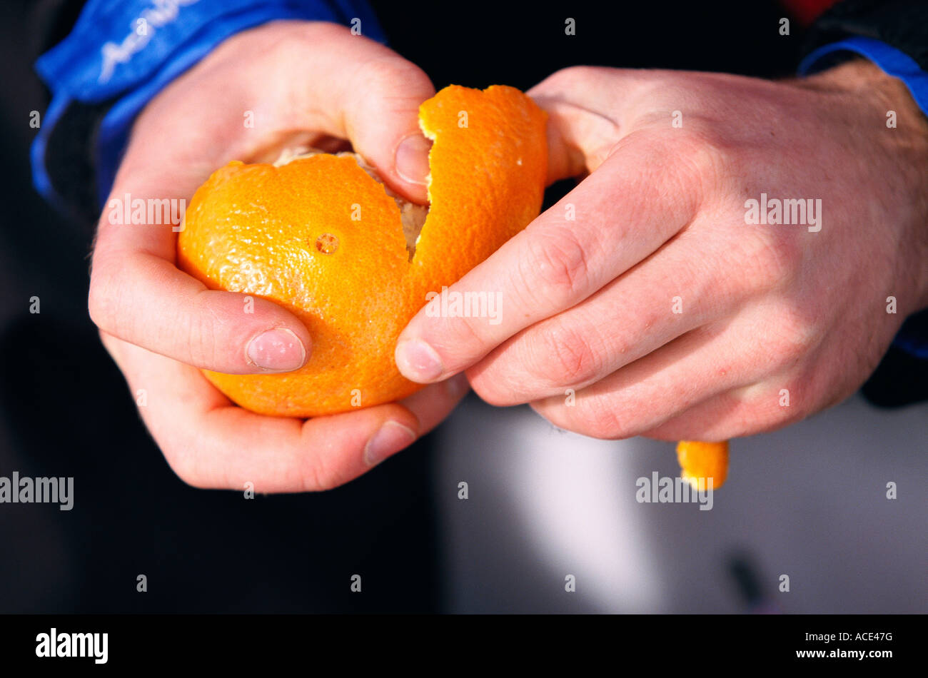 An orange being peeled Stock Photo - Alamy