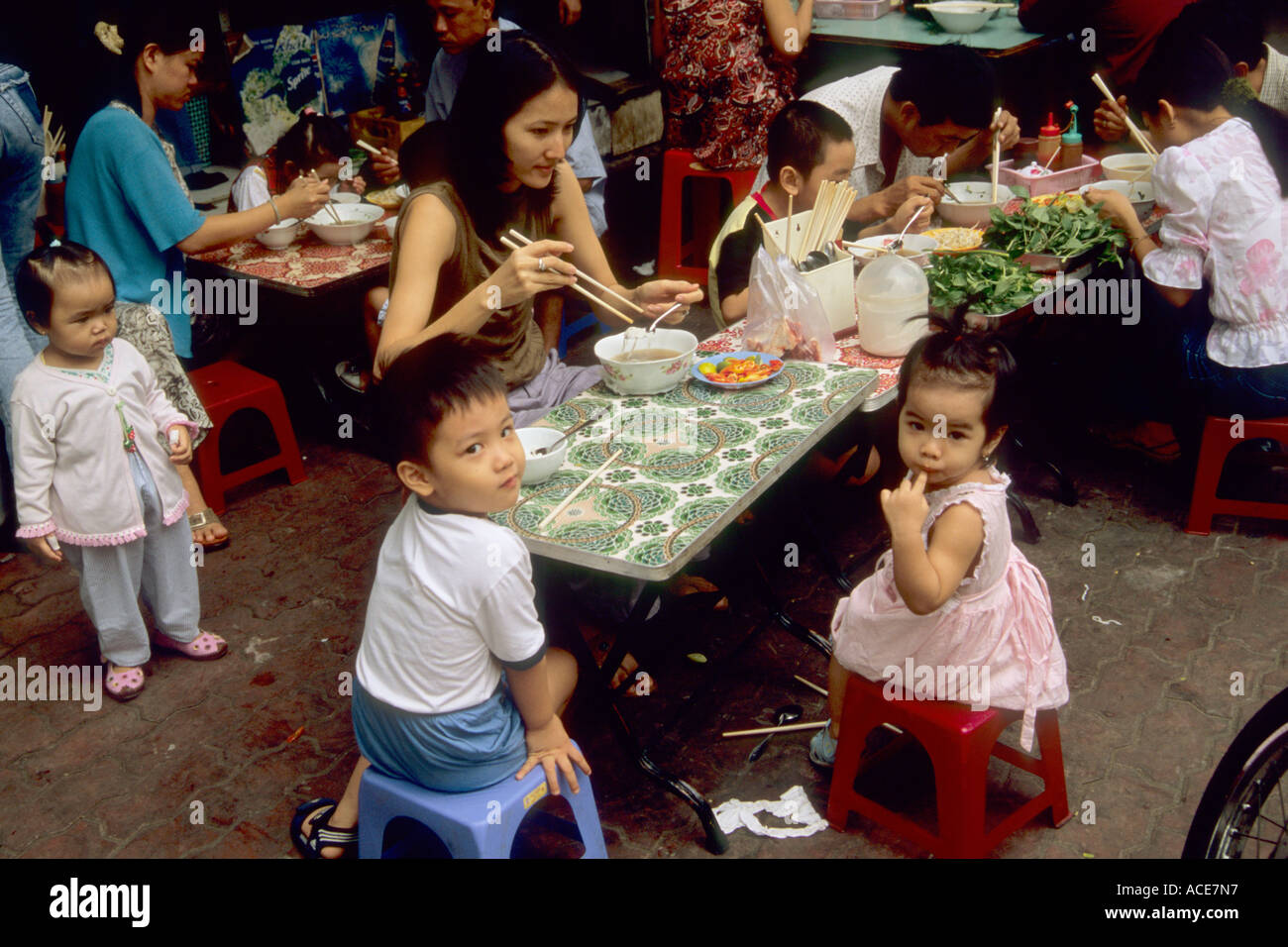 Vietnam Ho Chi Minh City Saigon people eating in the street Stock Photo ...