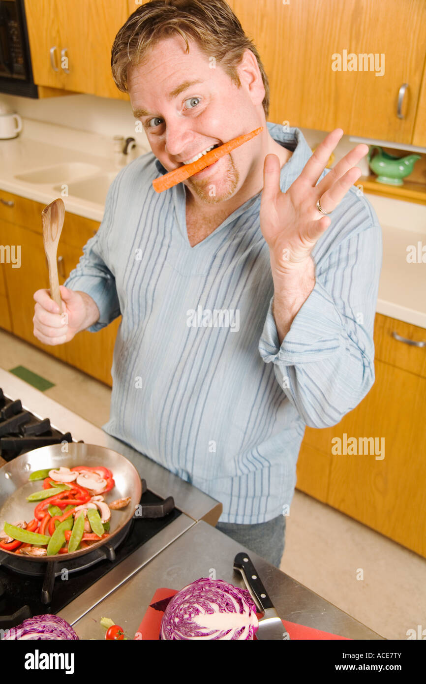Man playing with food while cooking Stock Photo - Alamy