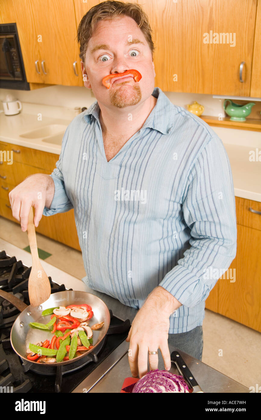 Man playing with food while cooking Stock Photo - Alamy
