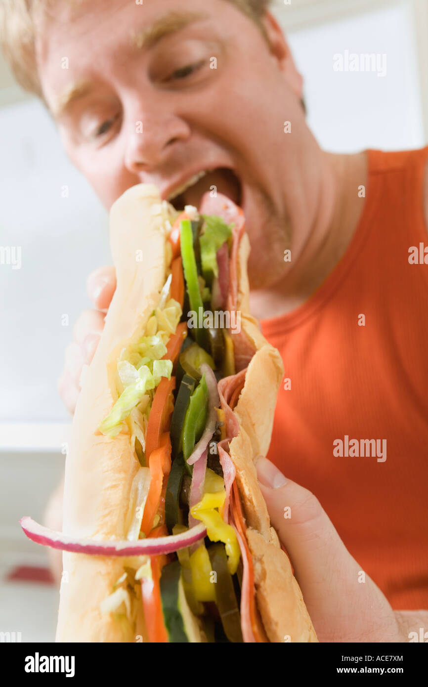 Man eating a big hoagie sandwich Stock Photo - Alamy