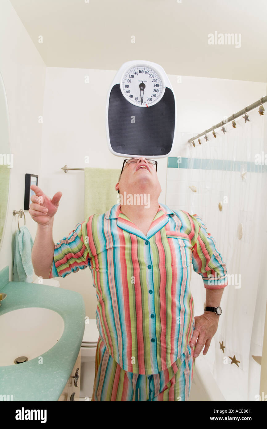 Man balancing a scale on his nose Stock Photo - Alamy