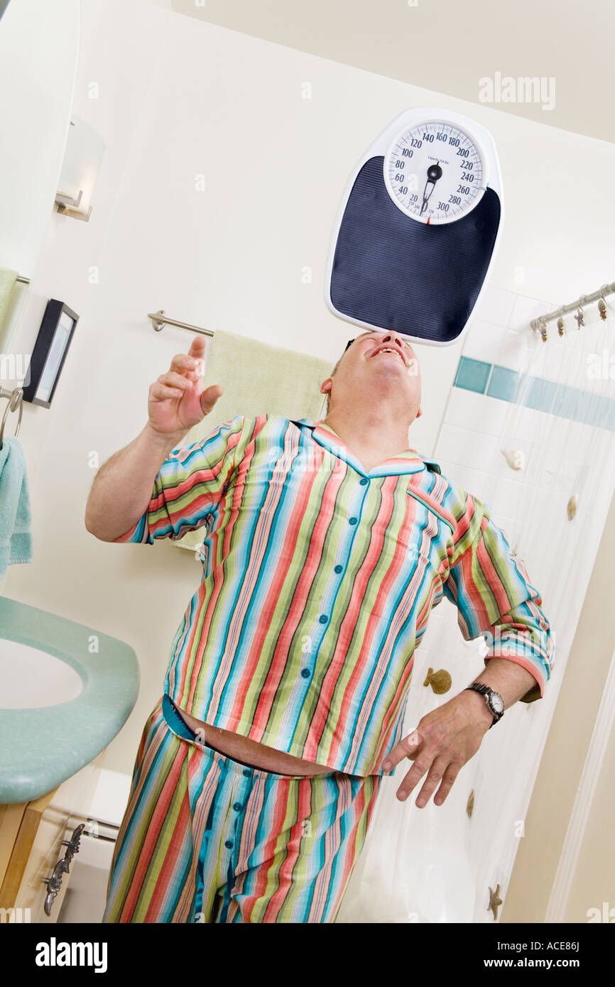 Man balancing a scale on his nose Stock Photo - Alamy