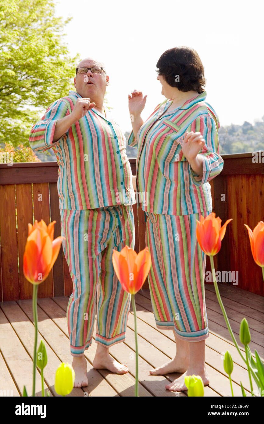 Couple dancing on patio in matching pajamas Stock Photo - Alamy
