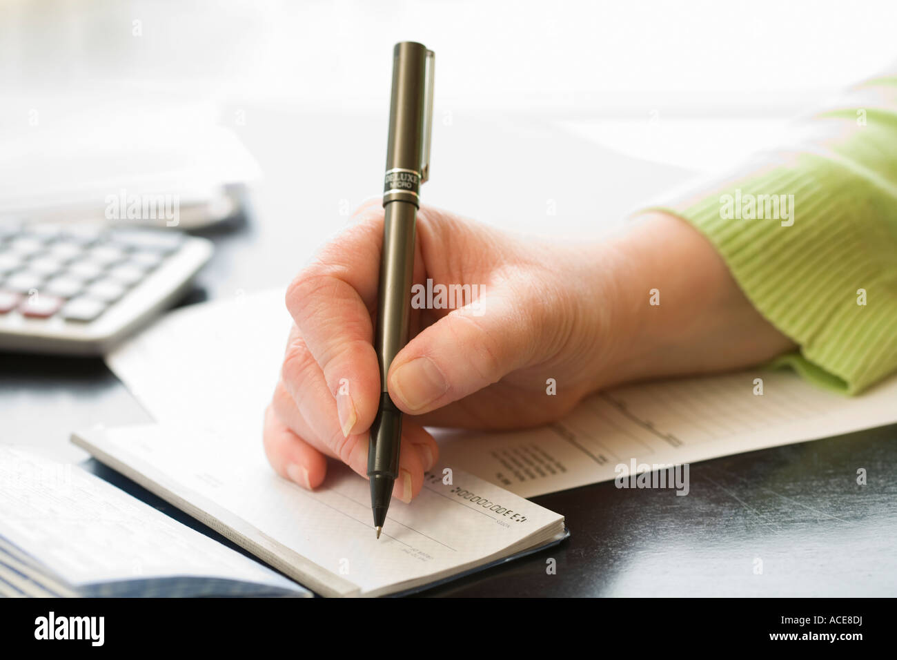 Man writing a check Stock Photo - Alamy