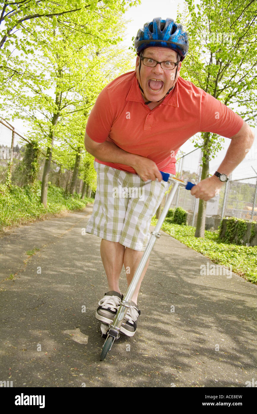 Man riding a scooter Stock Photo - Alamy