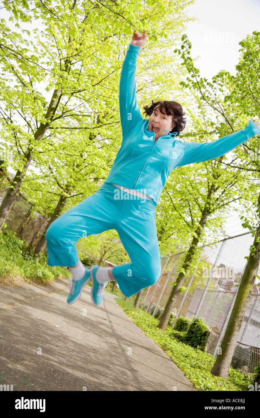 Woman jumping outside Stock Photo - Alamy