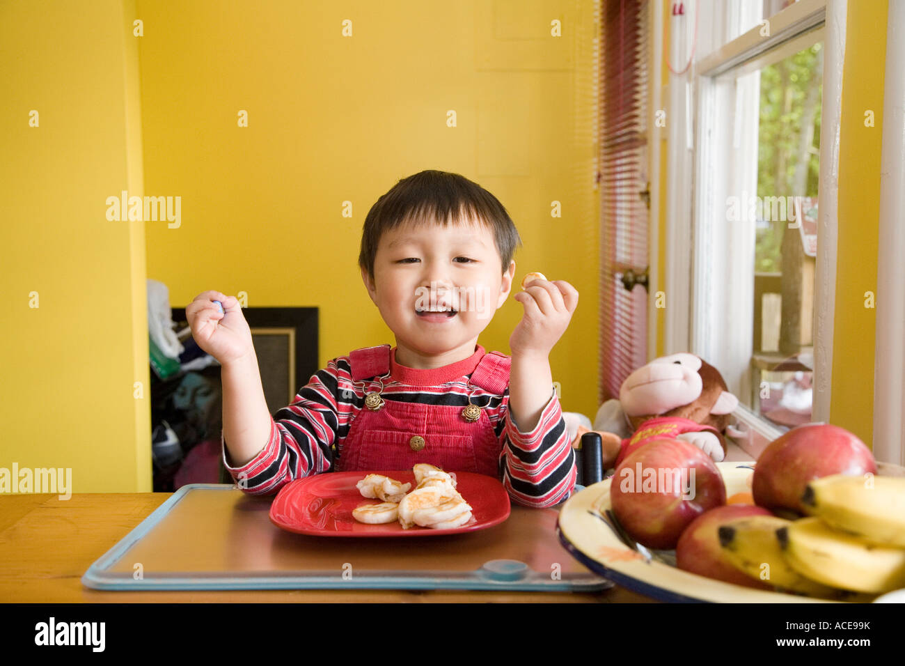 Young boy eating fruit Stock Photo - Alamy