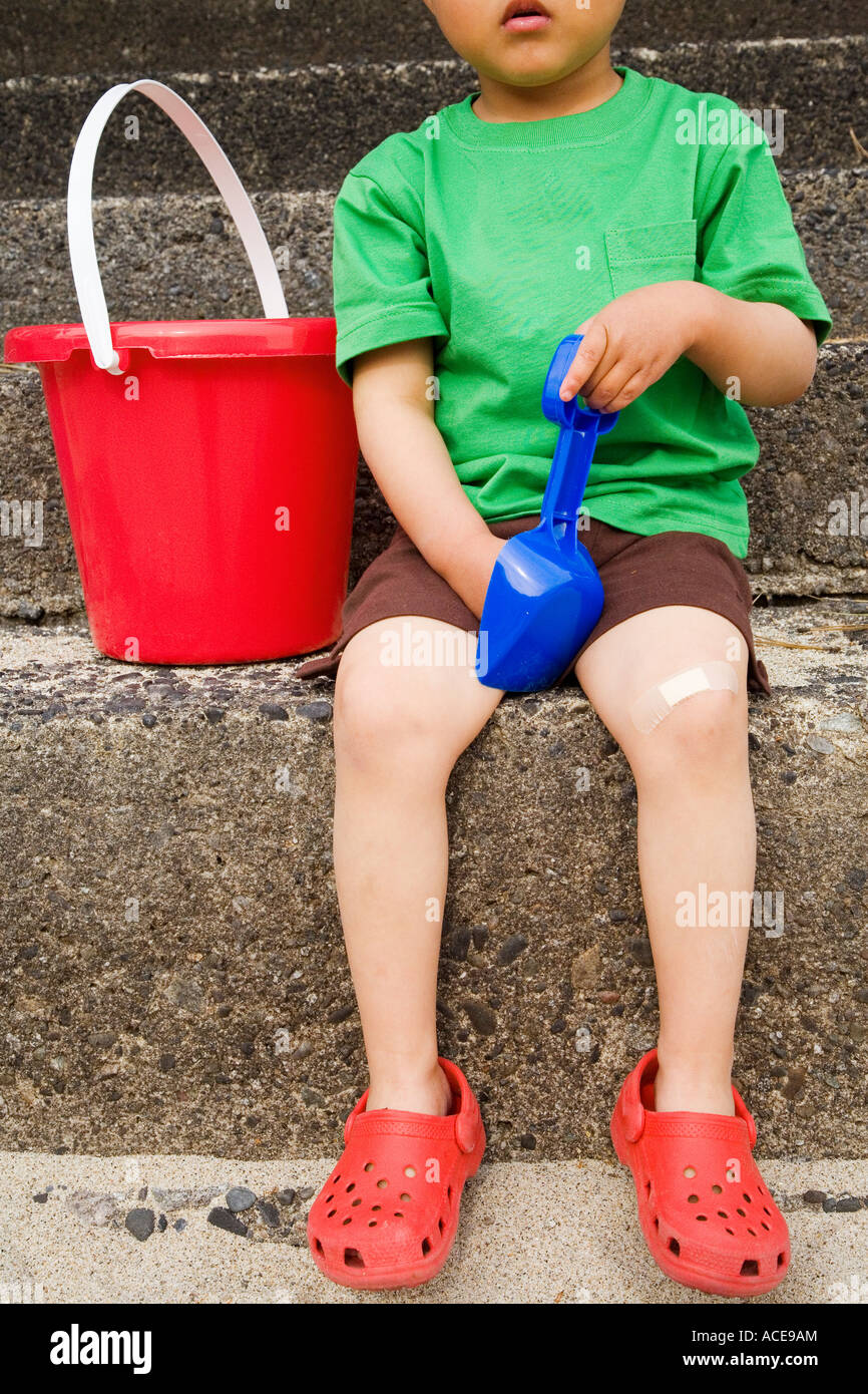 Young boy holding shovel and bucket Stock Photo - Alamy
