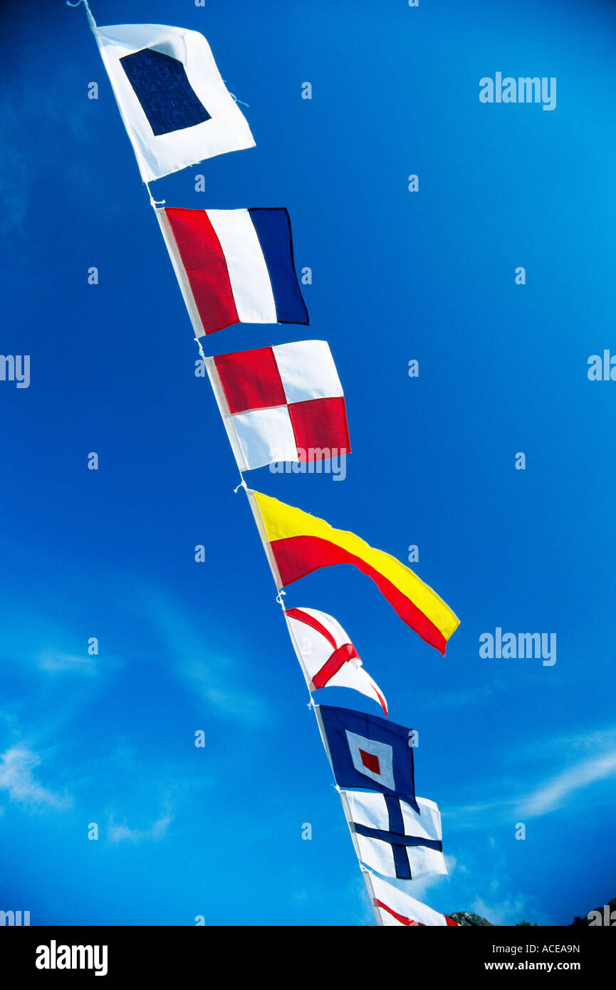 Flags on a rope blue sky in the background Stock Photo - Alamy