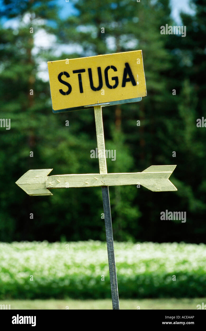 A sign with the text stuga cottage and an arrow Stock Photo - Alamy