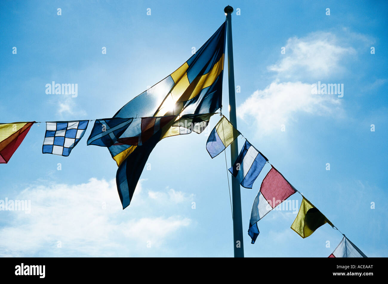 Flags in the wind blue sky in the background Stock Photo - Alamy