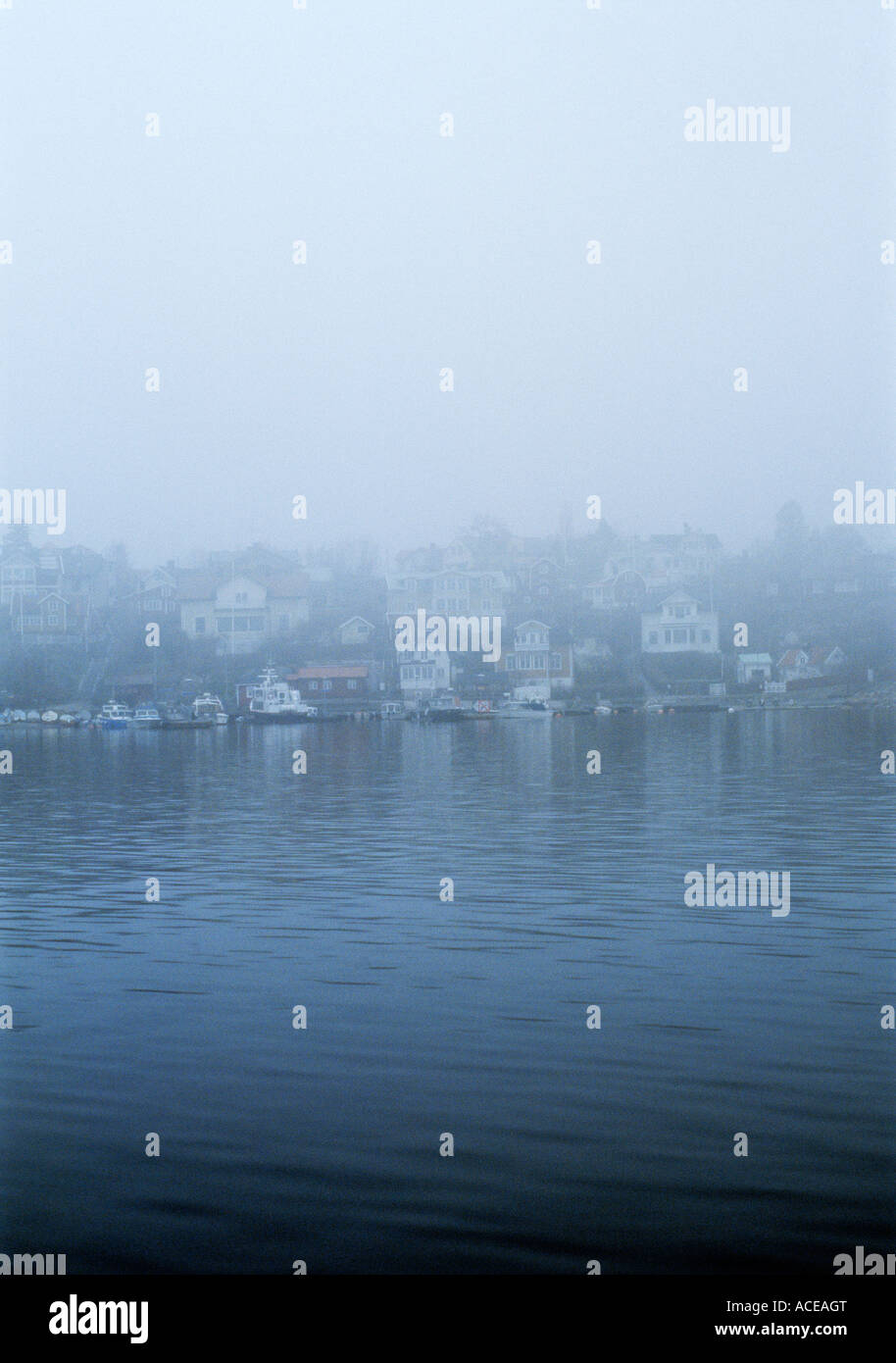 A community by the water concealed in fog Stock Photo - Alamy