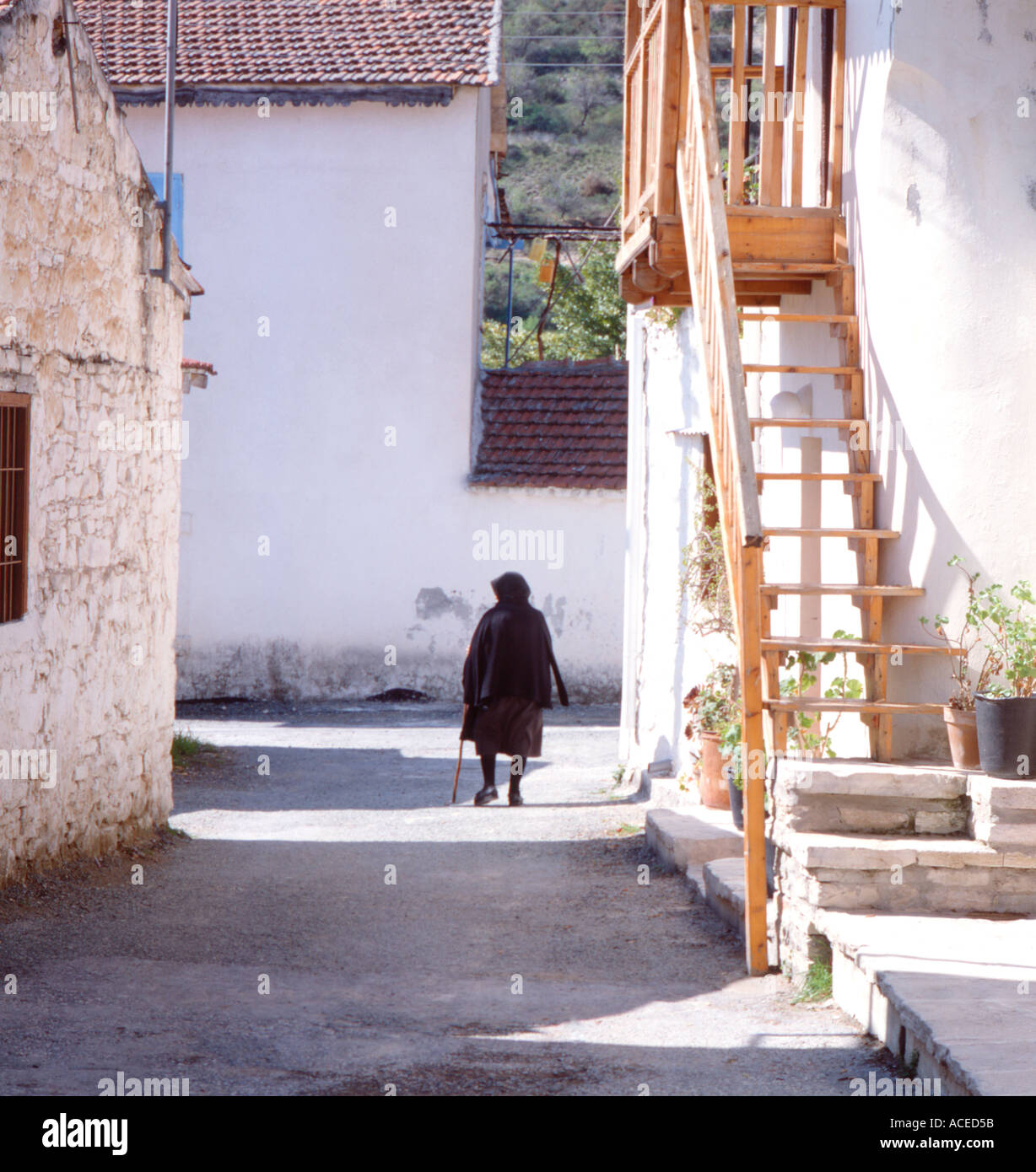 Old lady walking the street in Cyprus village Stock Photo - Alamy