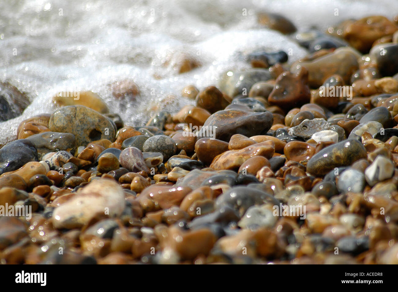 Sea washing over pebbles 1 Stock Photo - Alamy