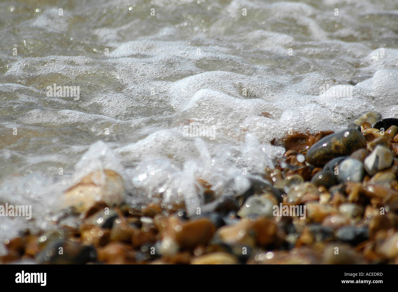 Sea washing over pebbles 3 Stock Photo - Alamy