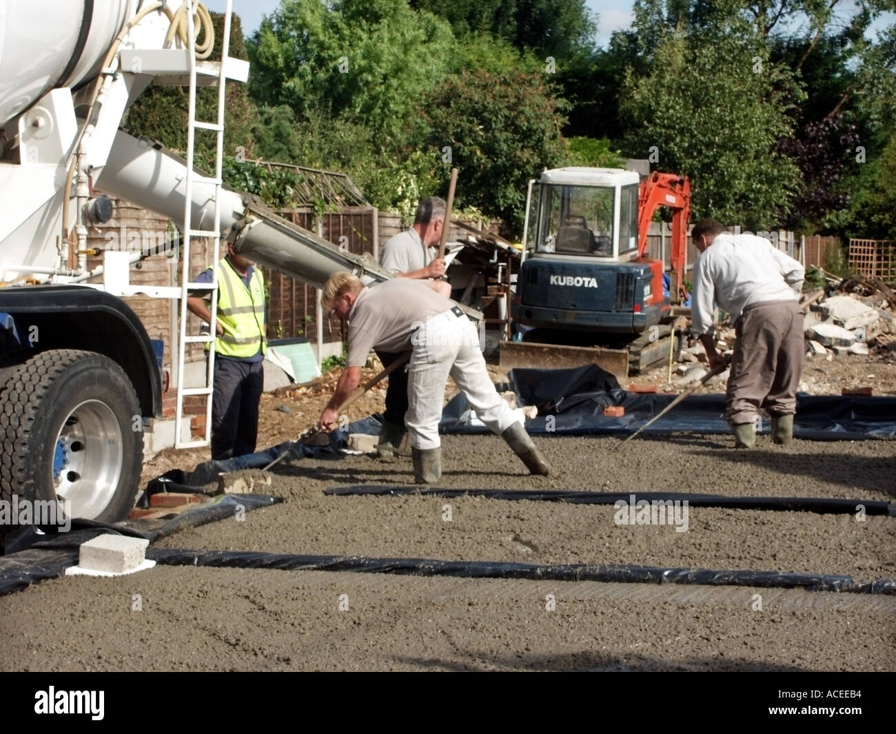 Ready mixed concrete lorry unloading into ground floor slab onto black ...