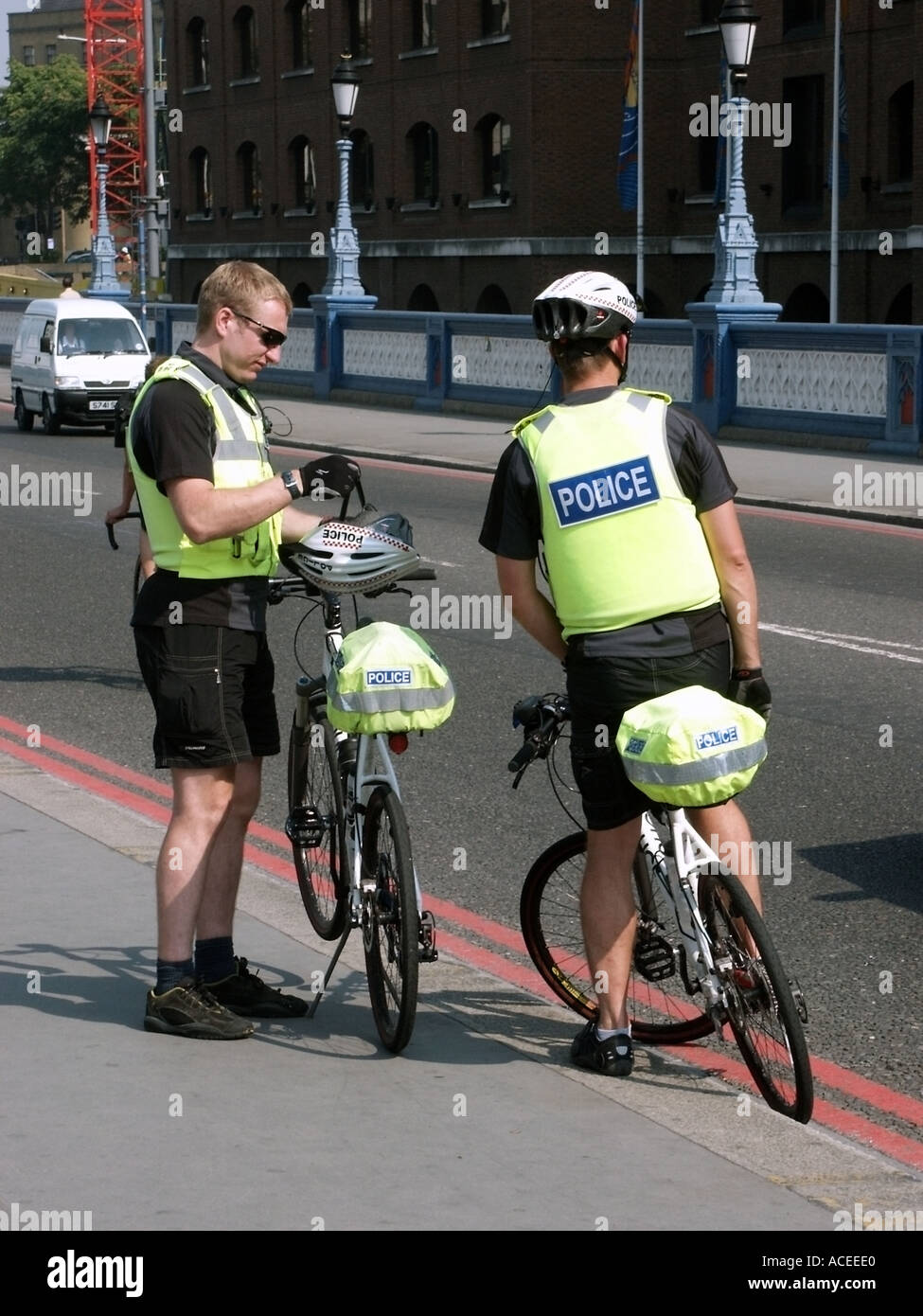 London pedal cyclist police patrolling Tower Bridge Road yellow high ...