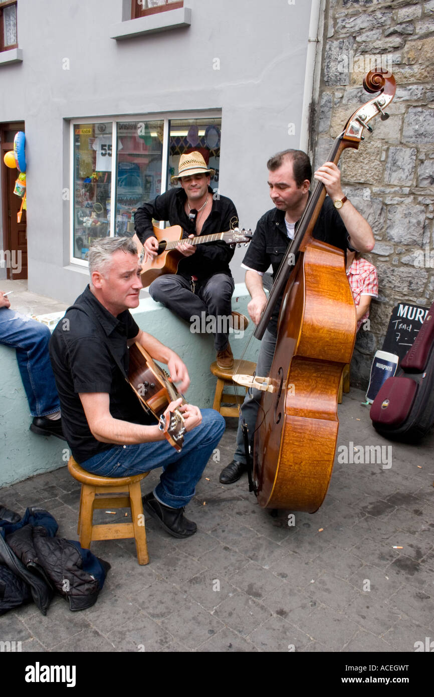 Group of musicians busking in street at Irish traditional music ...