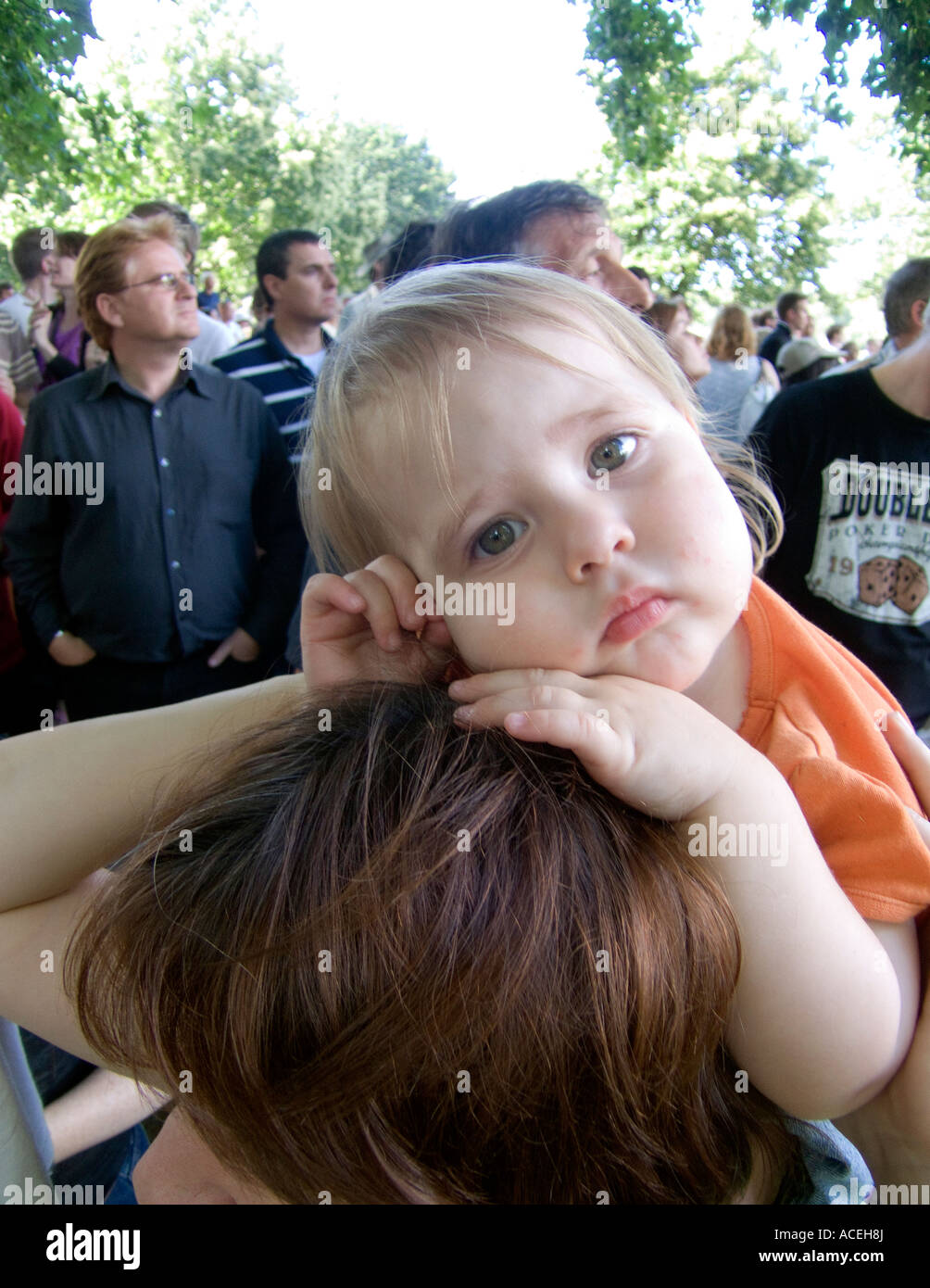 Child resting on mother after a long day out Stock Photo - Alamy