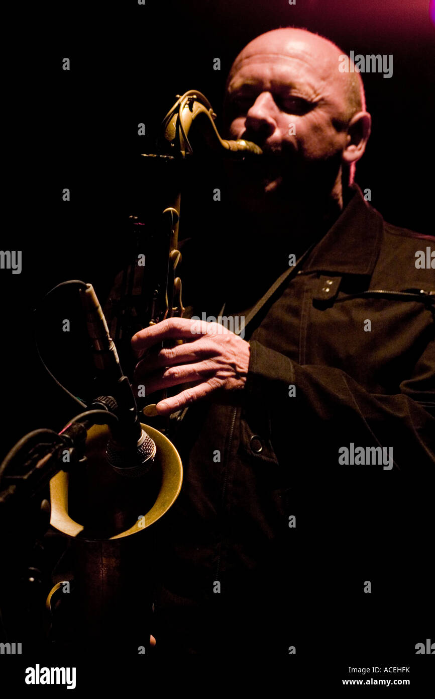 Musician playing saxophone into microphone live on stage Stock Photo ...