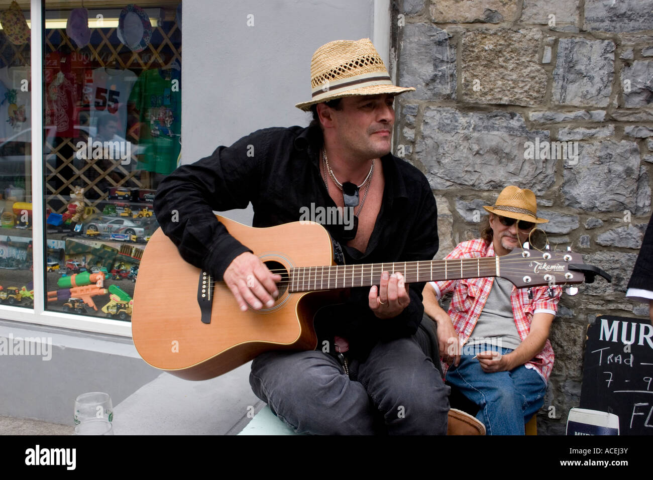 Man busking in street at Irish traditional music festival, county Kerry ...
