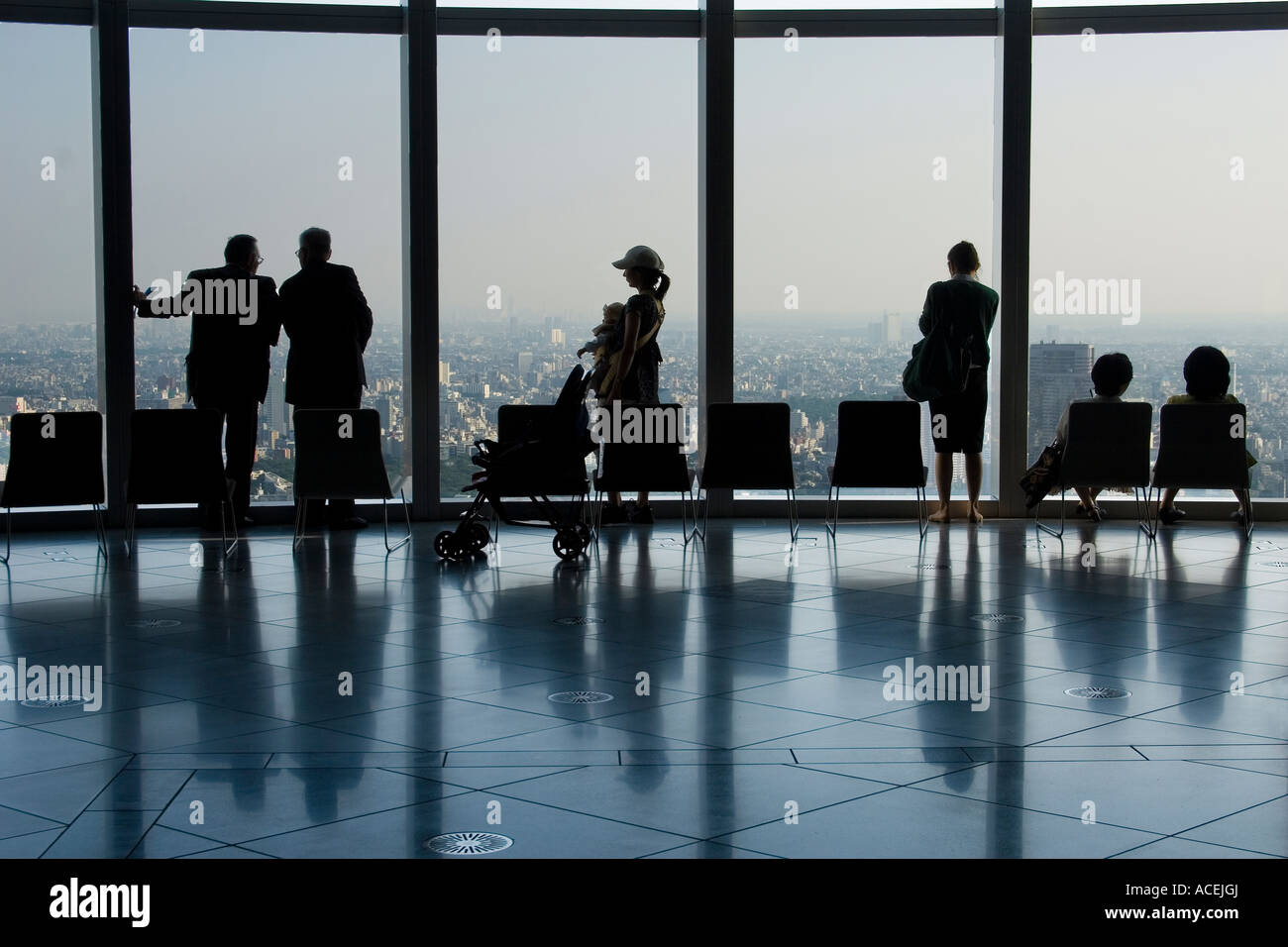 Silhouette of diverse people looking out a picture window atop an ...