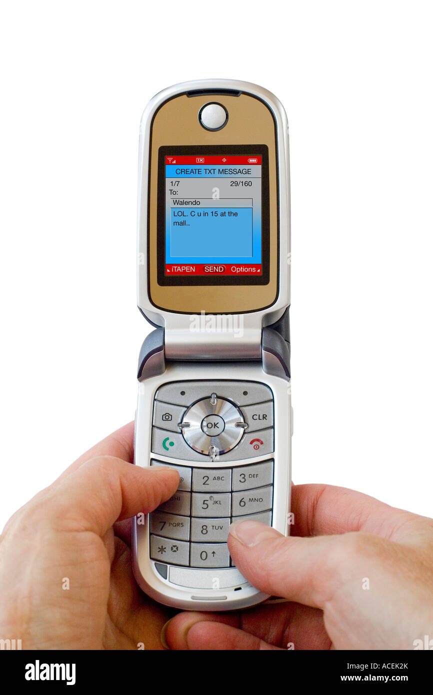 Hands holding a mobile phone with the thumbs tapping out the letters of ...