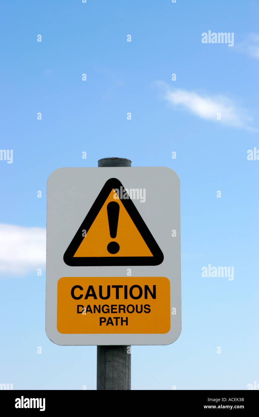 Caution dangerous path sign against blue sky Stock Photo - Alamy