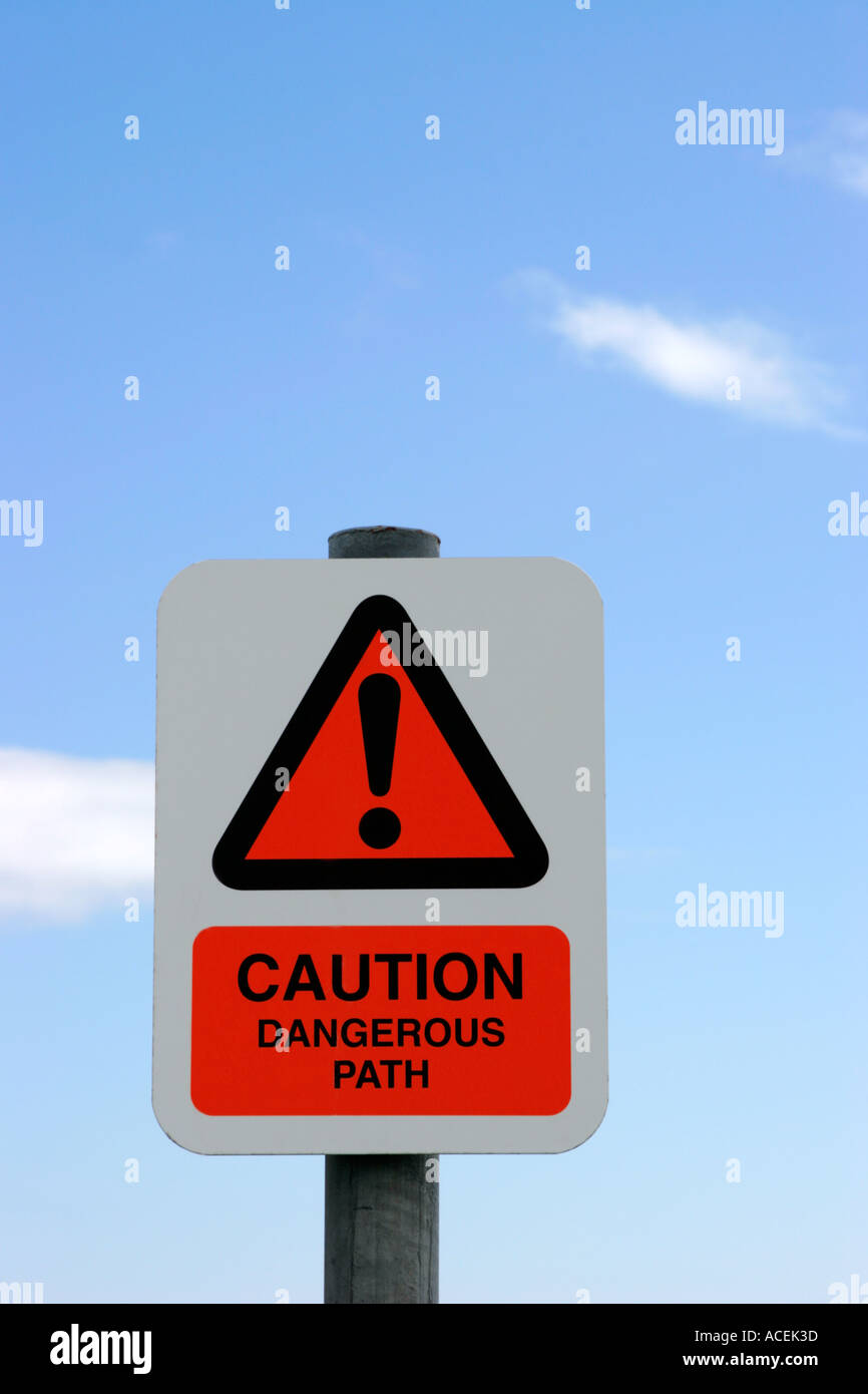 Caution dangerous path sign against blue sky Stock Photo - Alamy