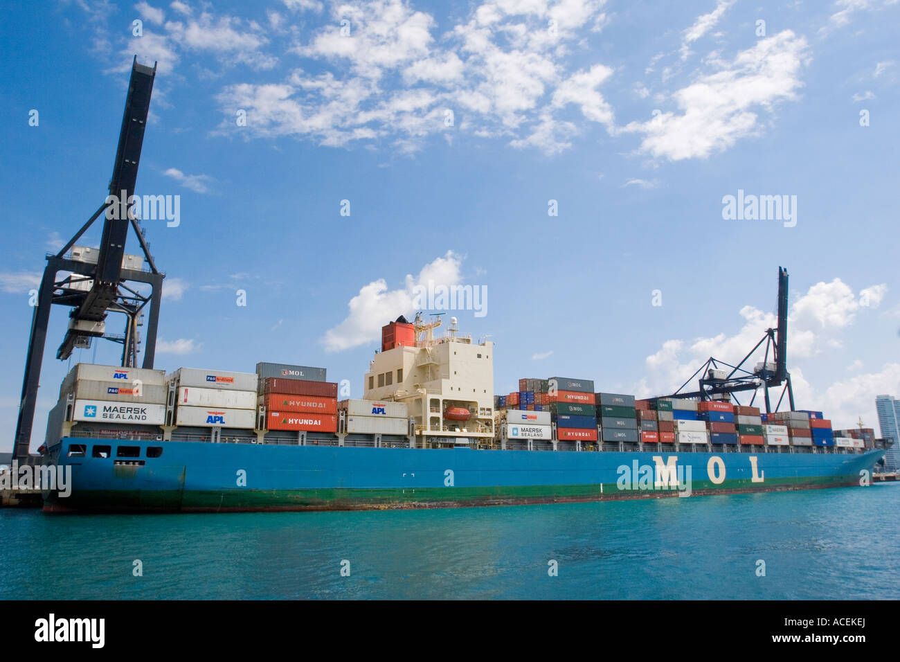 Container ship loaded with cargo docked at Port of Miami beside two ...