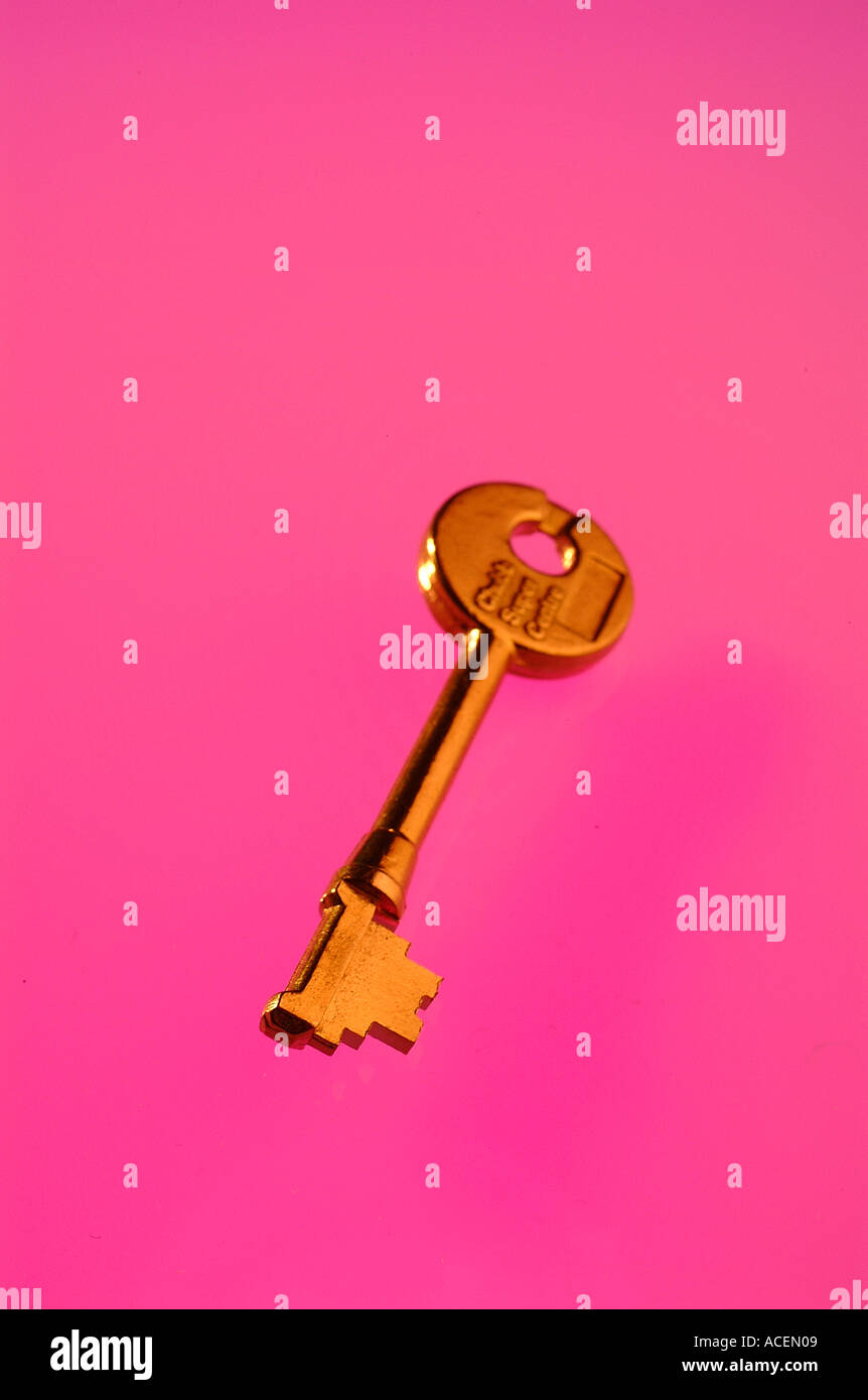 Gold key on pink background old style key for door locks contrasted ...