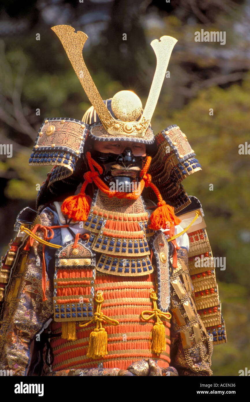 Man dressed in samurai warrior armor with kabuto helmet and face mask ...