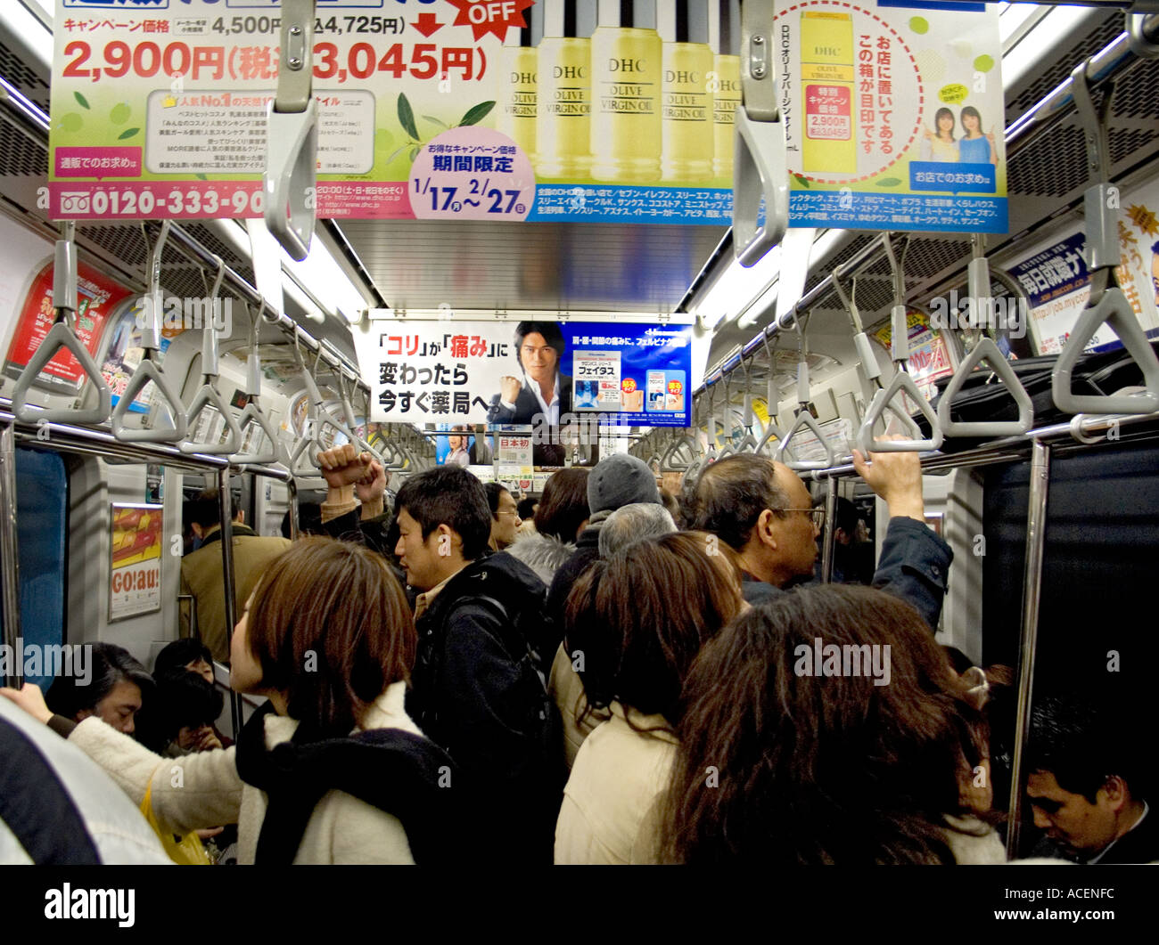 Interior view of commuters riding on a crowded Tokyo subway train ...
